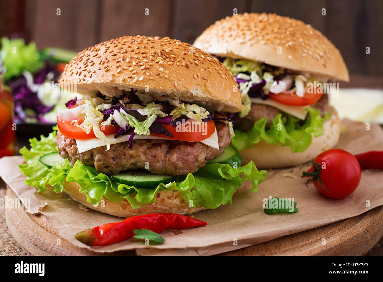 Sandwich hamburger with juicy burgers, cheese and mix of cabbage Stock ...