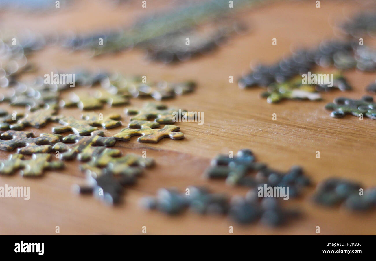 Jigsaw Puzzle pieces scattered across a table Stock Photo - Alamy Jigsaw Puzzle pieces scattered across a table Stock Photo - Alamy