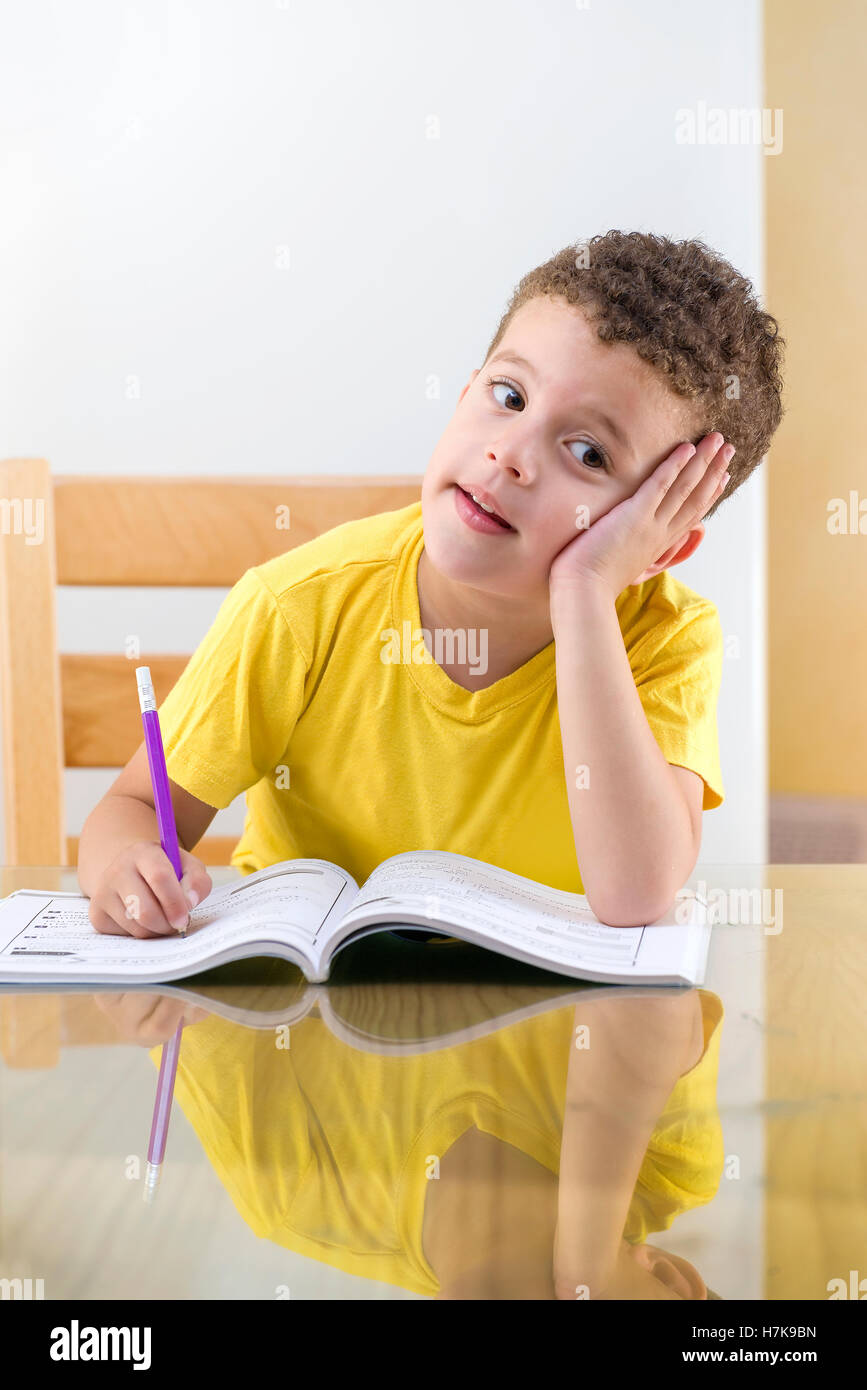A Young Schoolboy Thinking and Studying Stock Photo - Alamy
