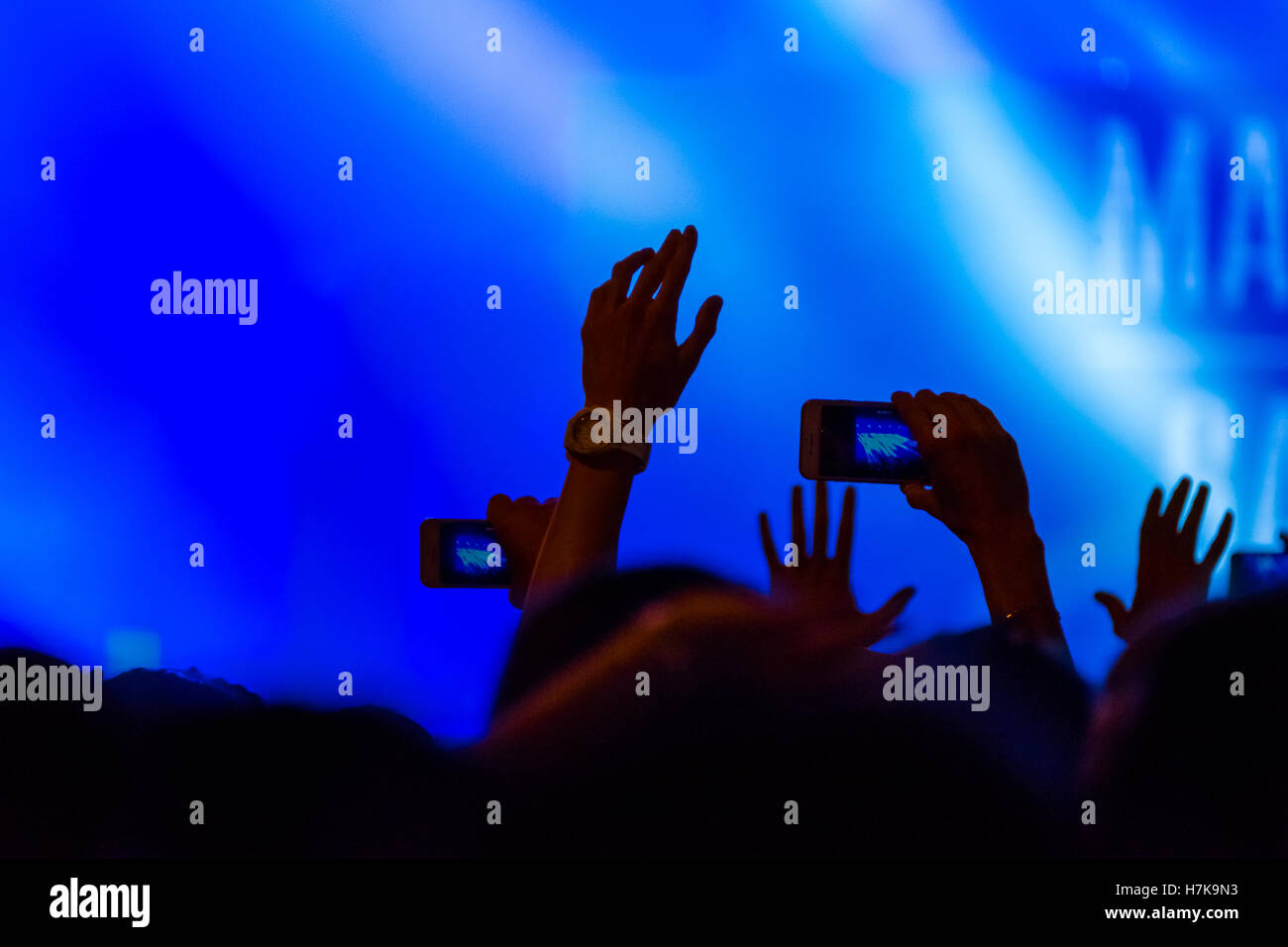 Fans cheering at open air live concert Stock Photo - Alamy
