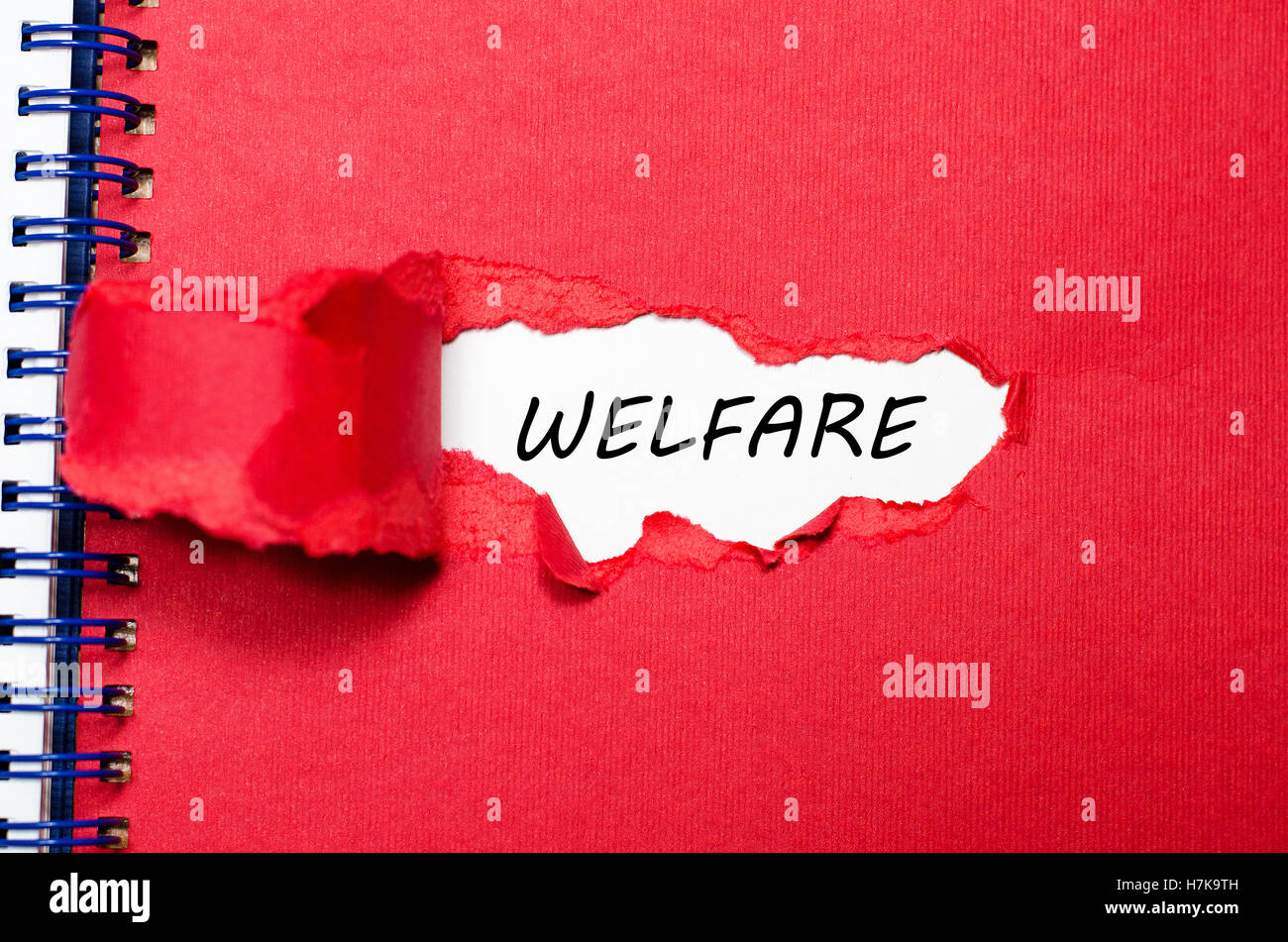 The word welfare appearing behind torn paper Stock Photo - Alamy