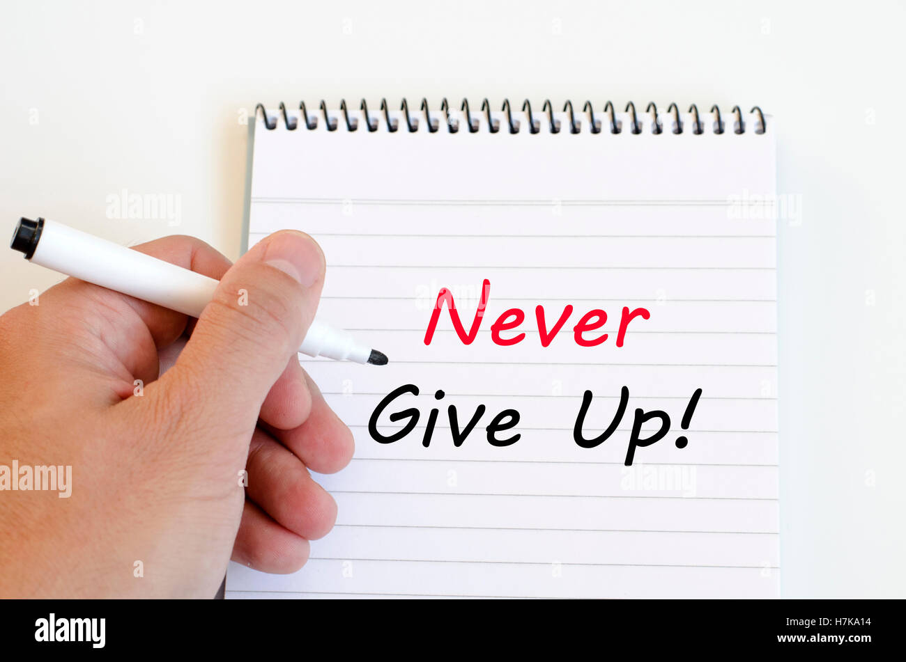 Never give up text concept write on notebook Stock Photo - Alamy