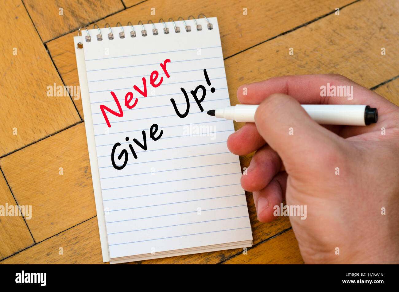Never give up text concept write on notebook Stock Photo - Alamy