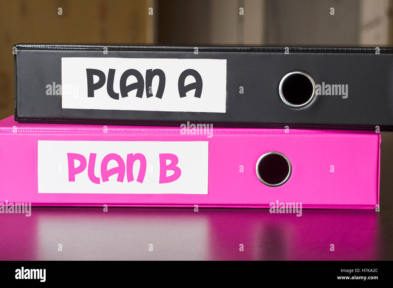 Bright office folders over dark background and plan a and plan b text ...