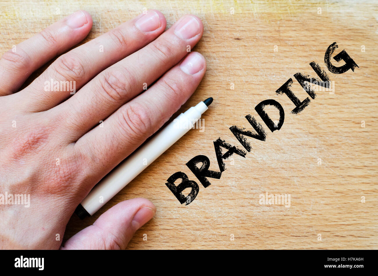 Human hand over wooden background and branding text concept Stock Photo ...