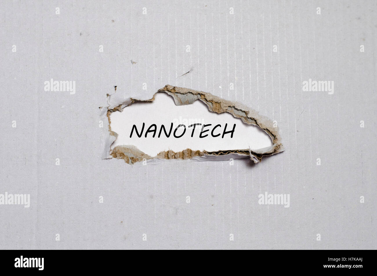 The word nanotech appearing behind torn paper Stock Photo - Alamy