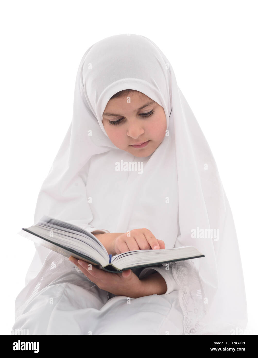 Young Muslim Girl Reading Quran Isolated On White Background Stock