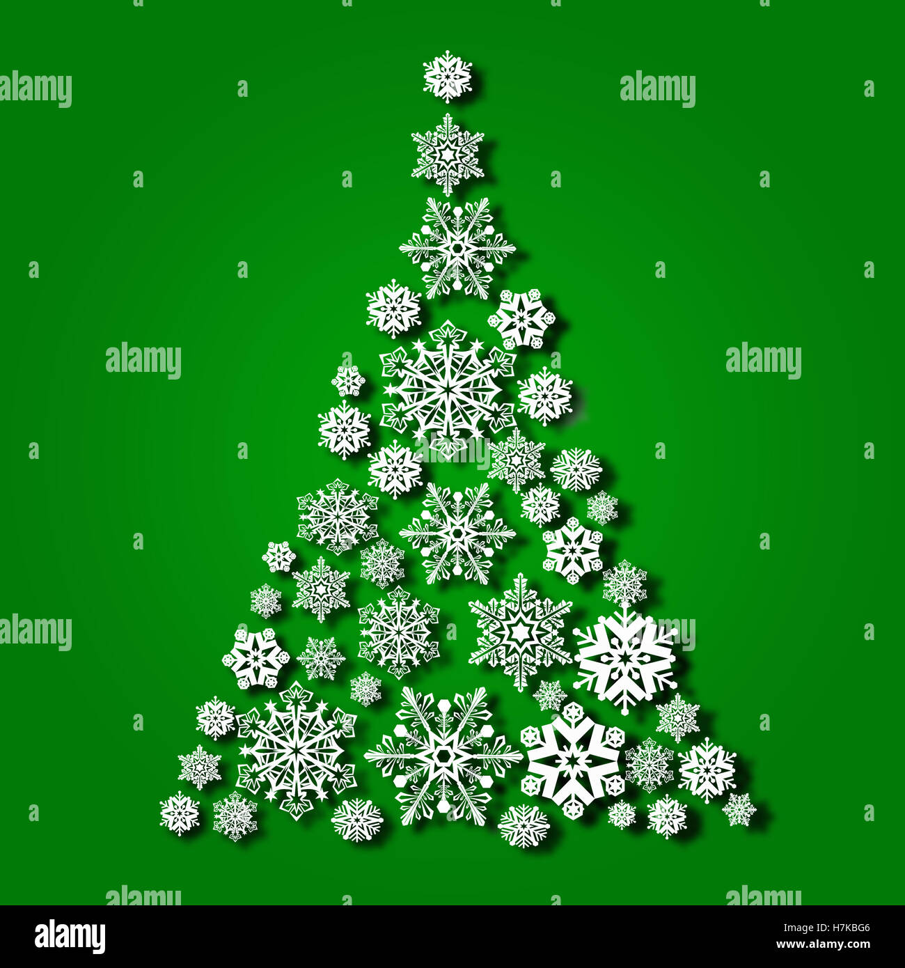 Christmas tree from snowflakes, casts a shadow on green background ...