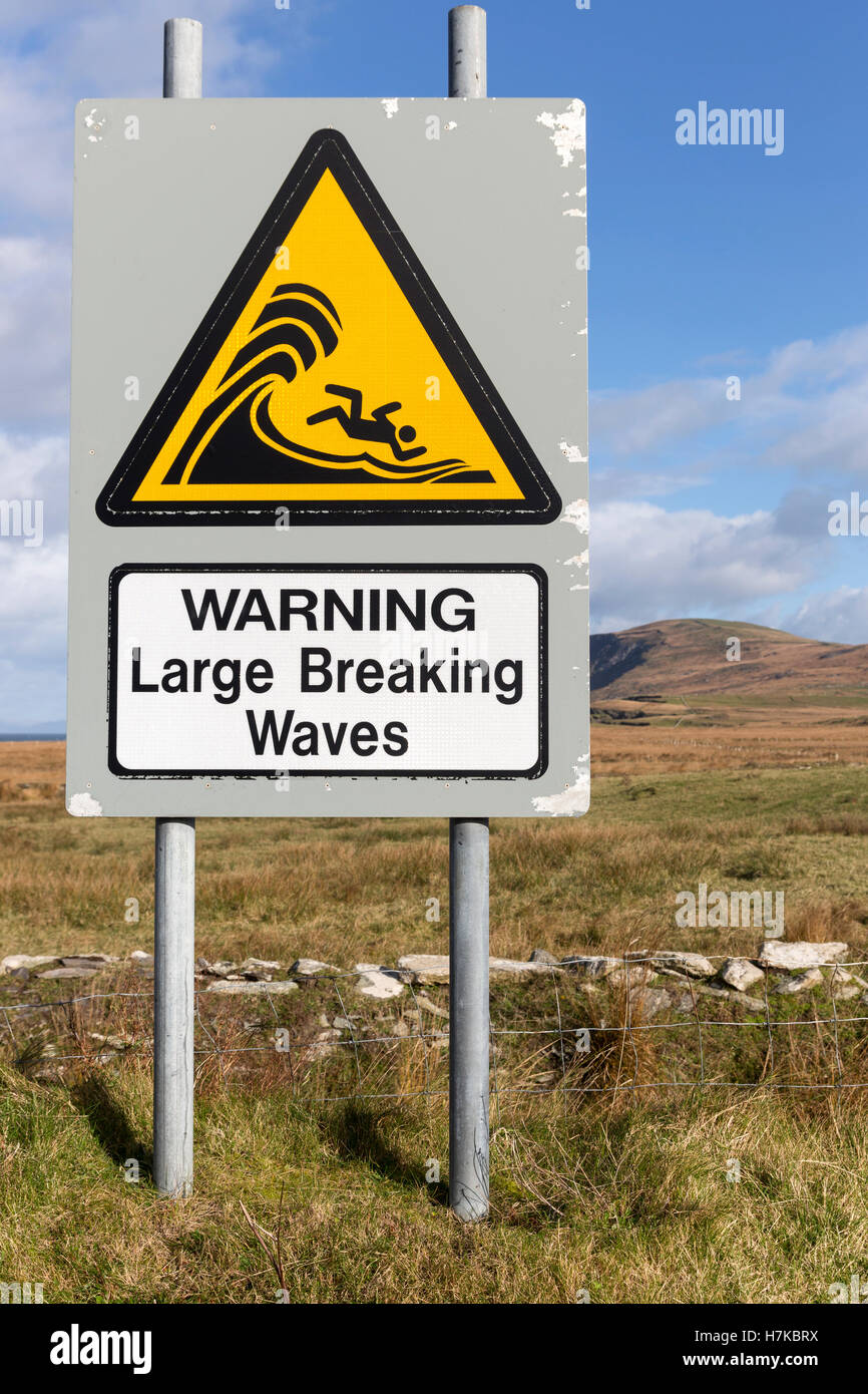 Danger, large breaking waves sign. Culoo Rock, Valentia Island, County ...