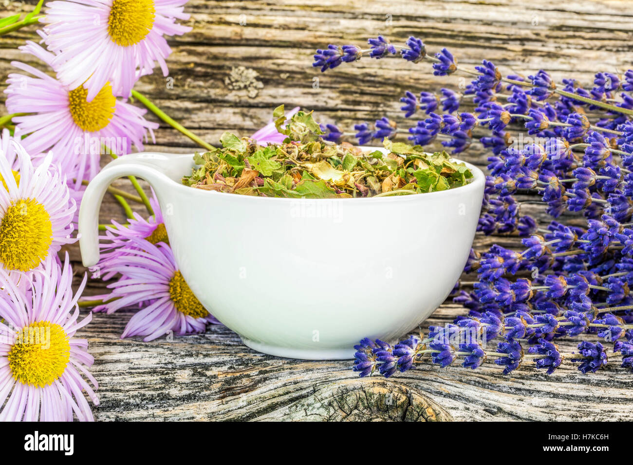 Natural herbal tea with meadow flowers around on a wood Stock Photo - Alamy