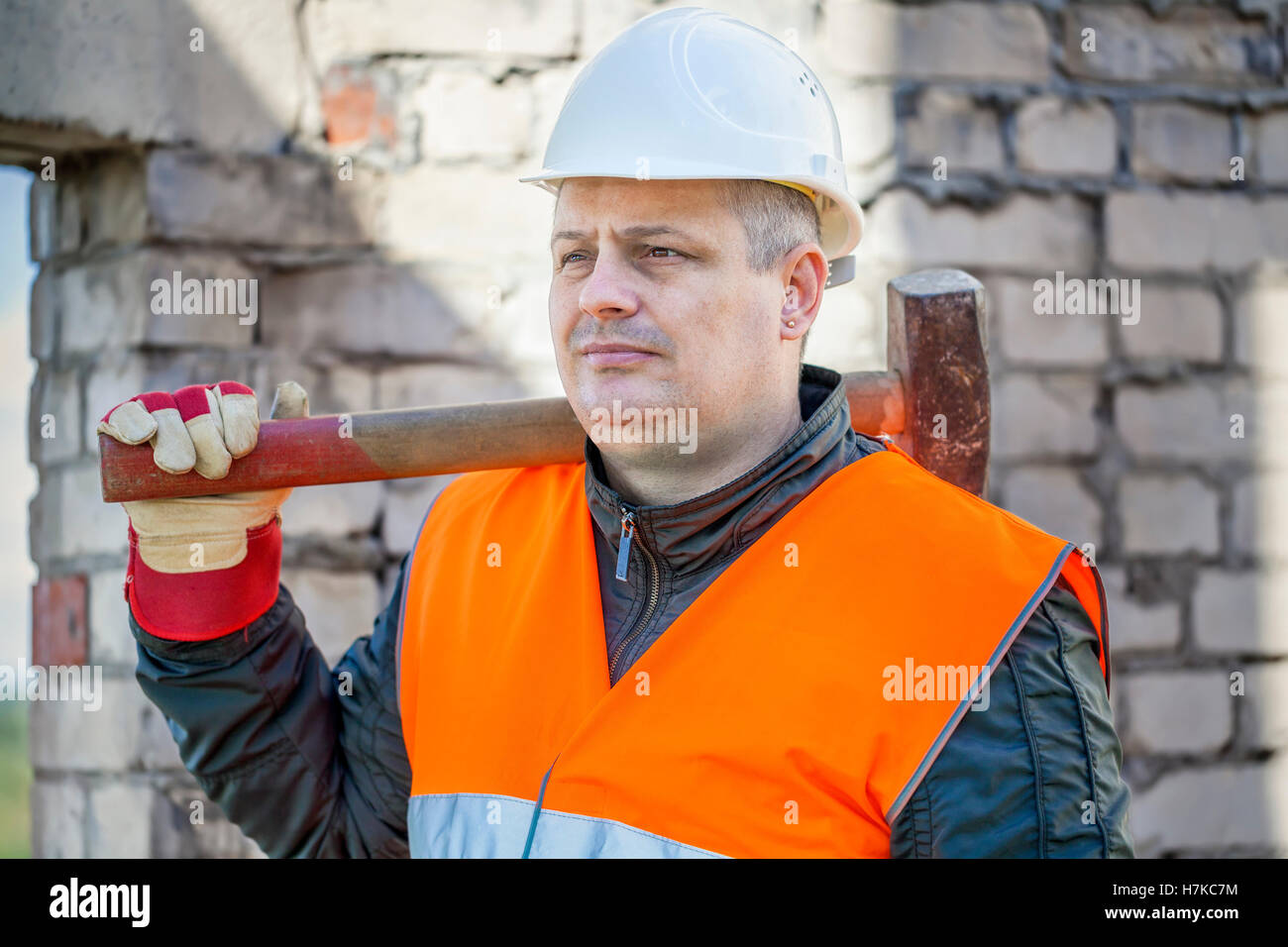 Construction worker with sledge hammer Stock Photo - Alamy