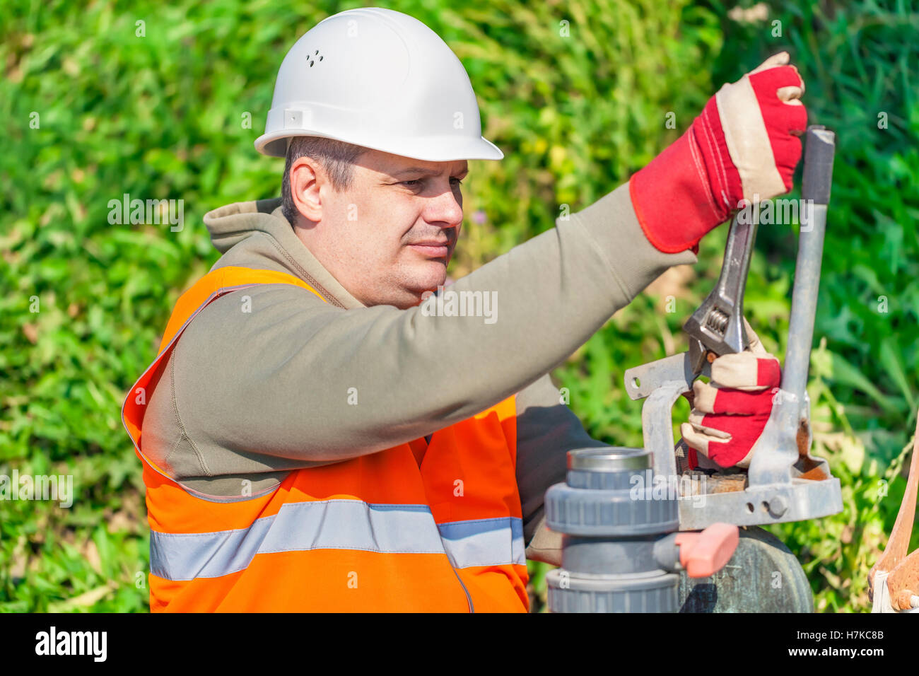 Worker with adjustable wrench Stock Photo - Alamy