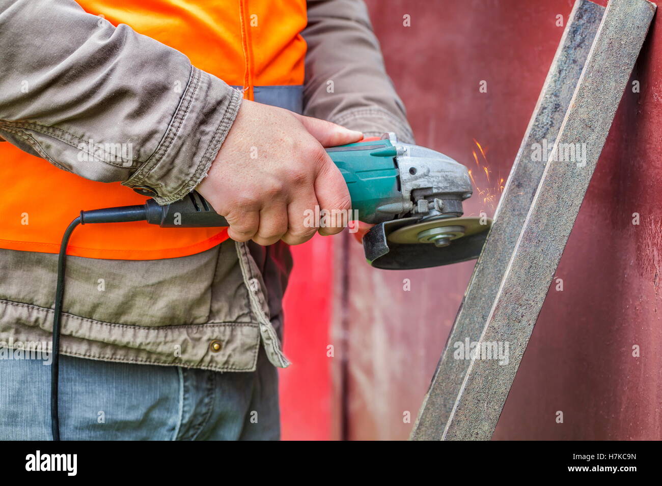 Worker with grinding machine cutting iron Stock Photo - Alamy