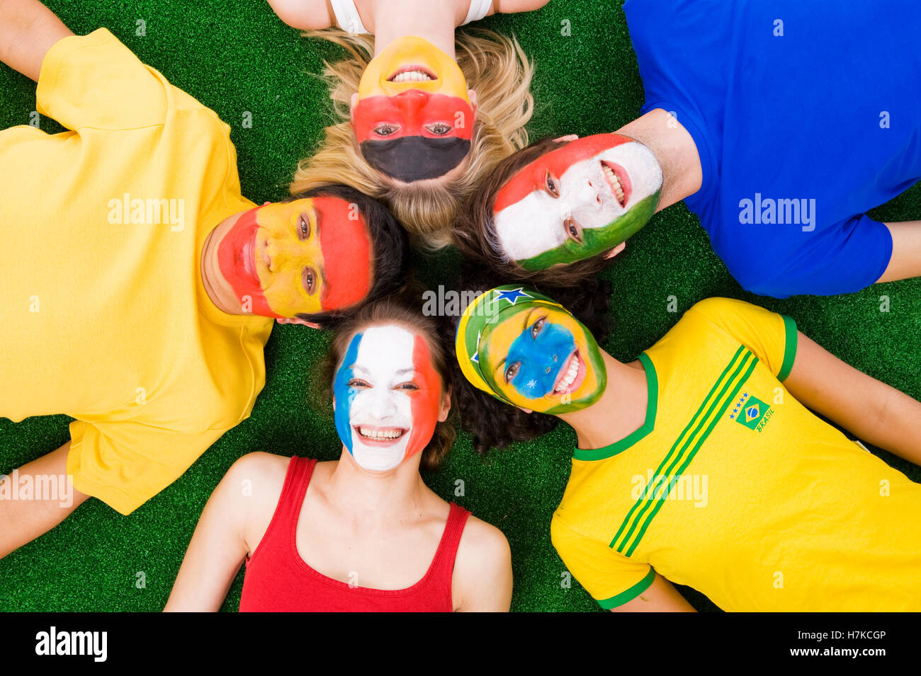 Young people with faces painted in different national colours Stock ...