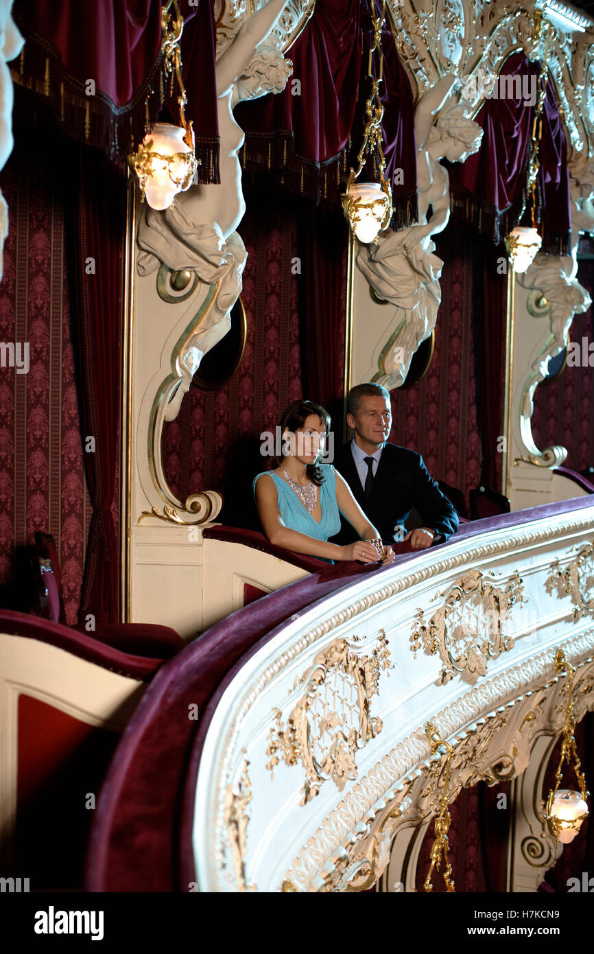 Couple seated in a theatre box, opera Stock Photo - Alamy