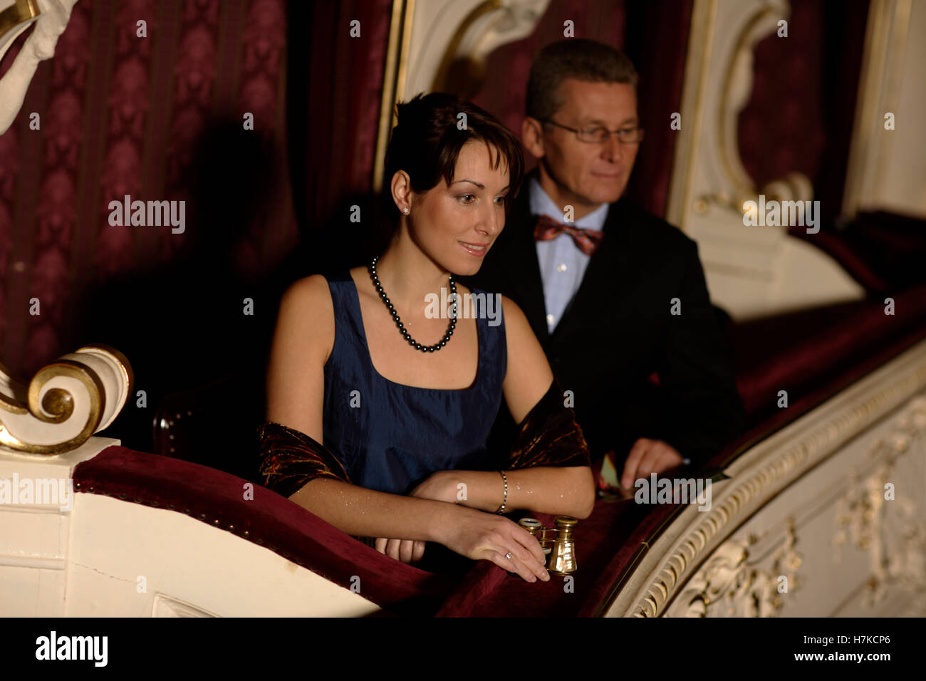 Couple seated in a theatre box, opera Stock Photo - Alamy