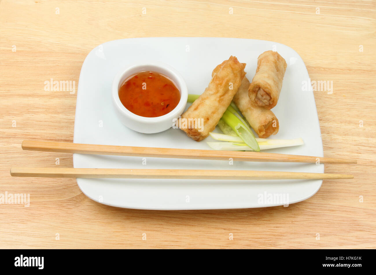 Spring rolls with spring onion and sweet chilli dipping sauce on a ...