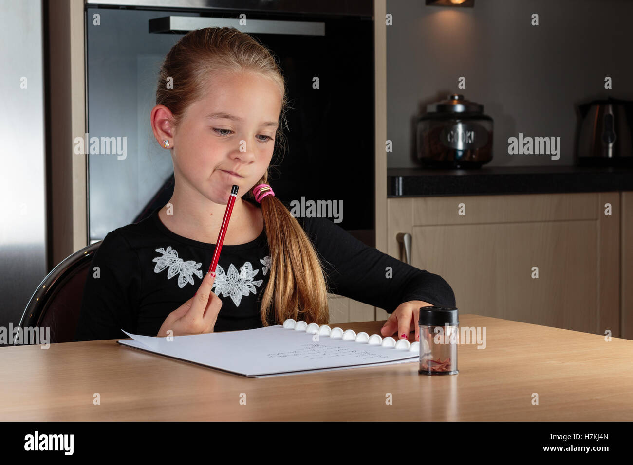 Woman thinking holding pencil hi-res stock photography and images - Alamy