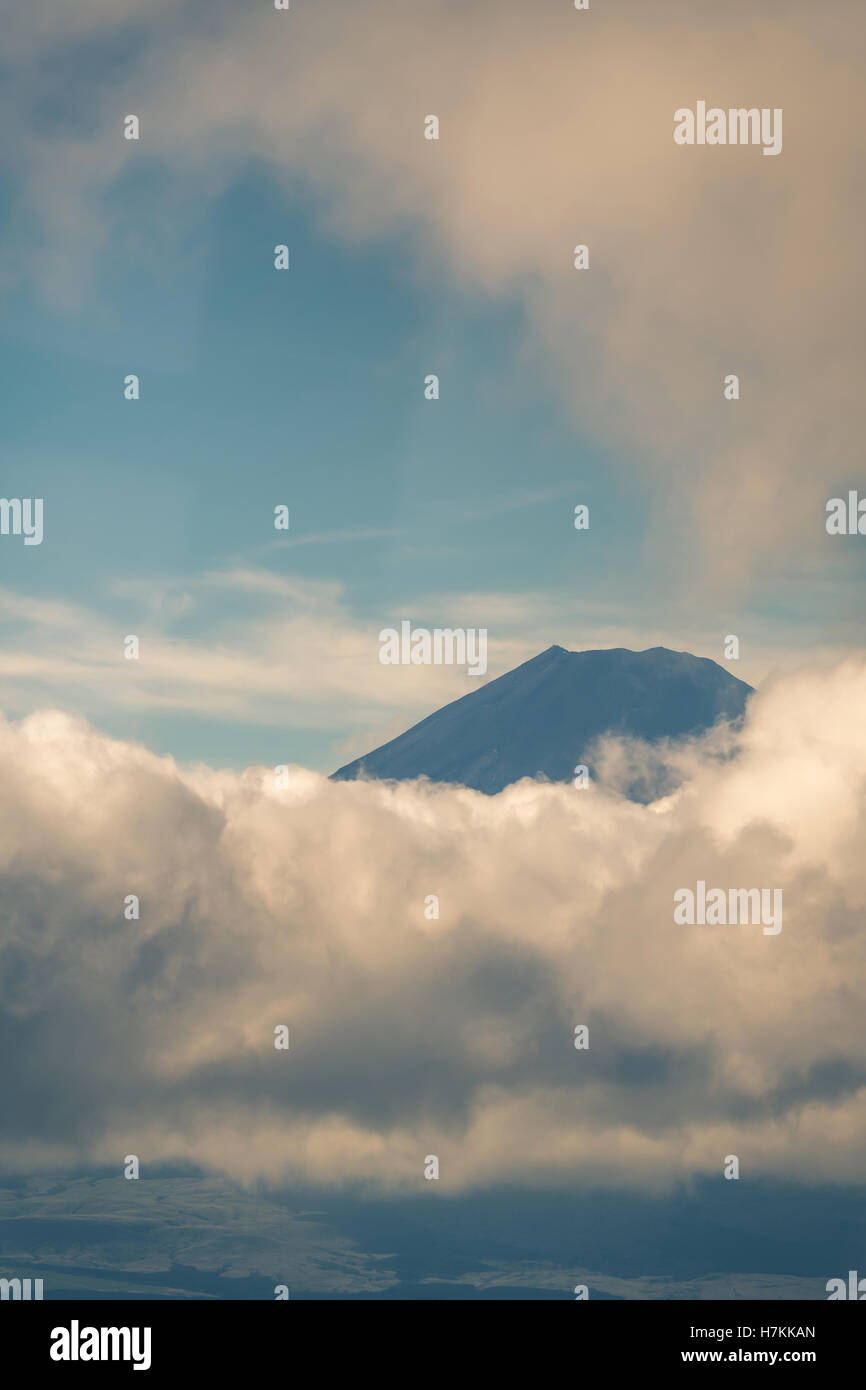 Portrait of mount Fuji summit peeking through clouds Stock Photo - Alamy