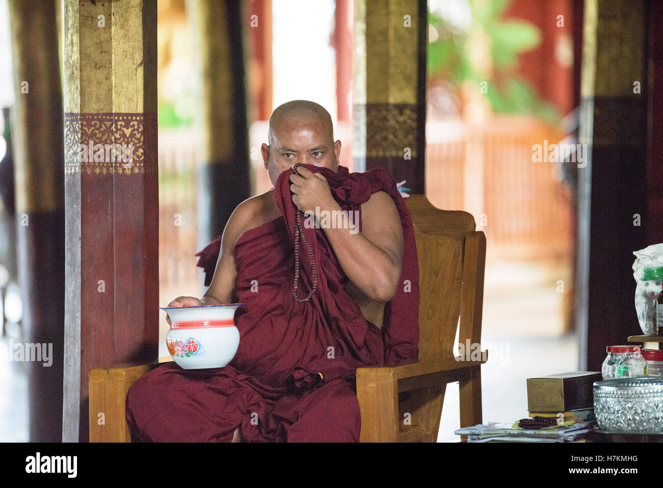 Buddhist monk, sitting on a chair in a temple Stock Photo - Alamy