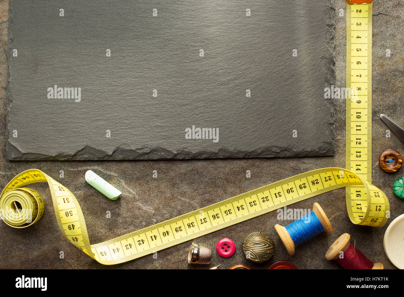 sewing tools and measuring tape on table background Stock Photo - Alamy