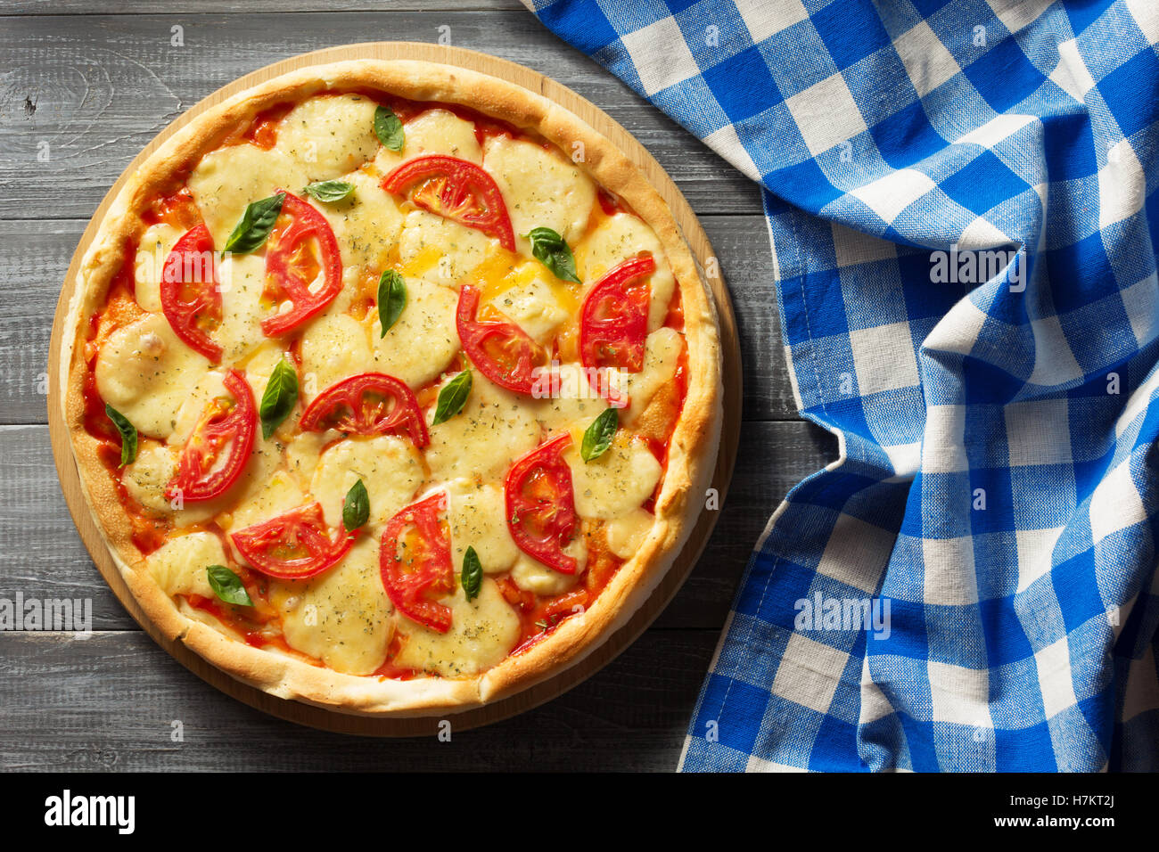italian pizza at wooden table Stock Photo - Alamy
