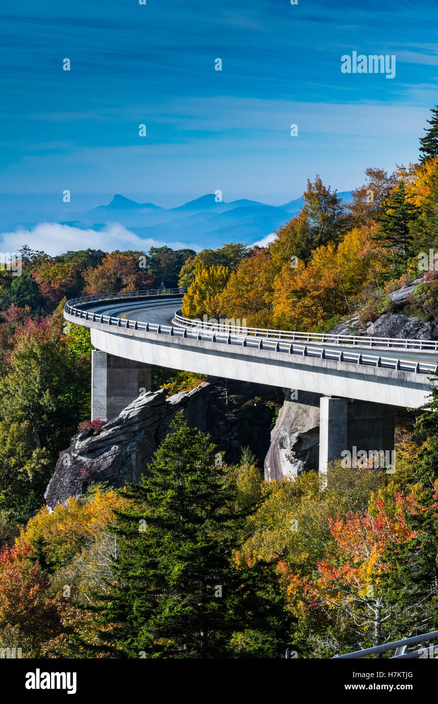 The Curve of Linn Cove Viaduct in Fall with wispy clouds in the valley ...