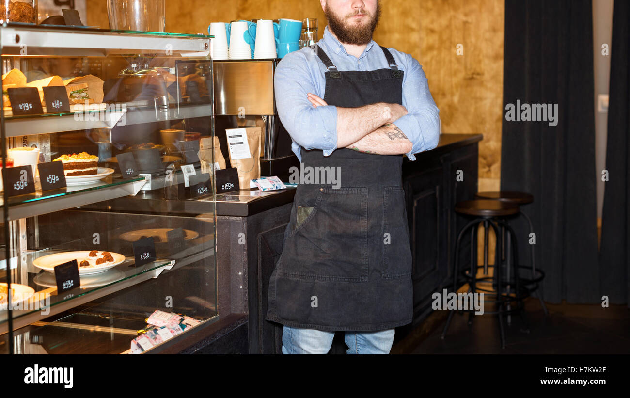 Barista stands next to the counter at his coffee shop Stock Photo - Alamy