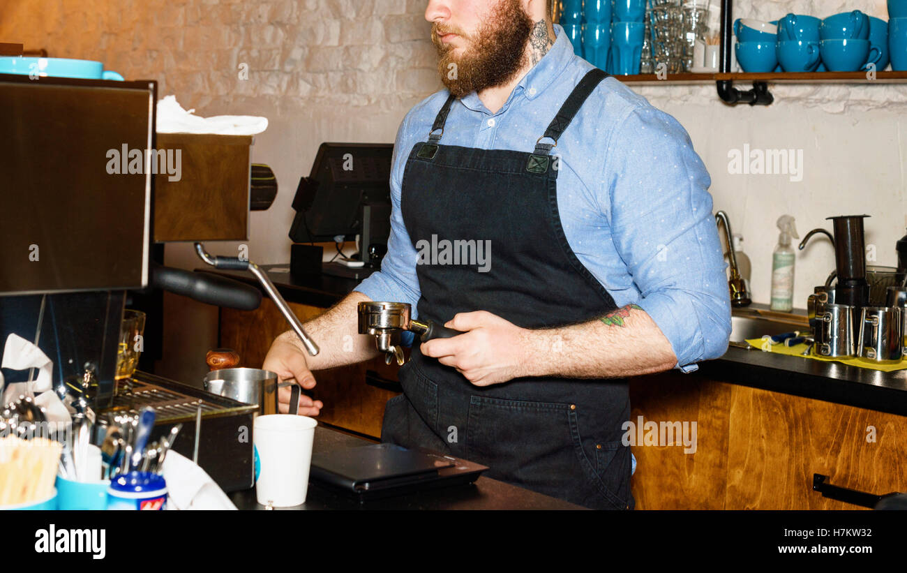 Barista making coffee using press Stock Photo - Alamy