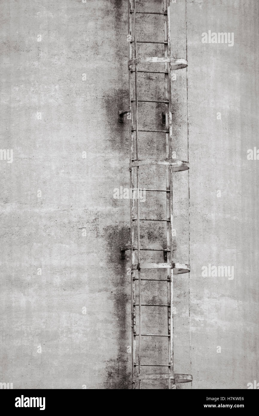 Exterior of old industrial building with ladder. Concrete architecture ...