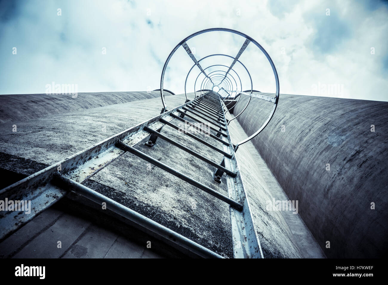 Exterior of old industrial building with ladder. Concrete architecture ...