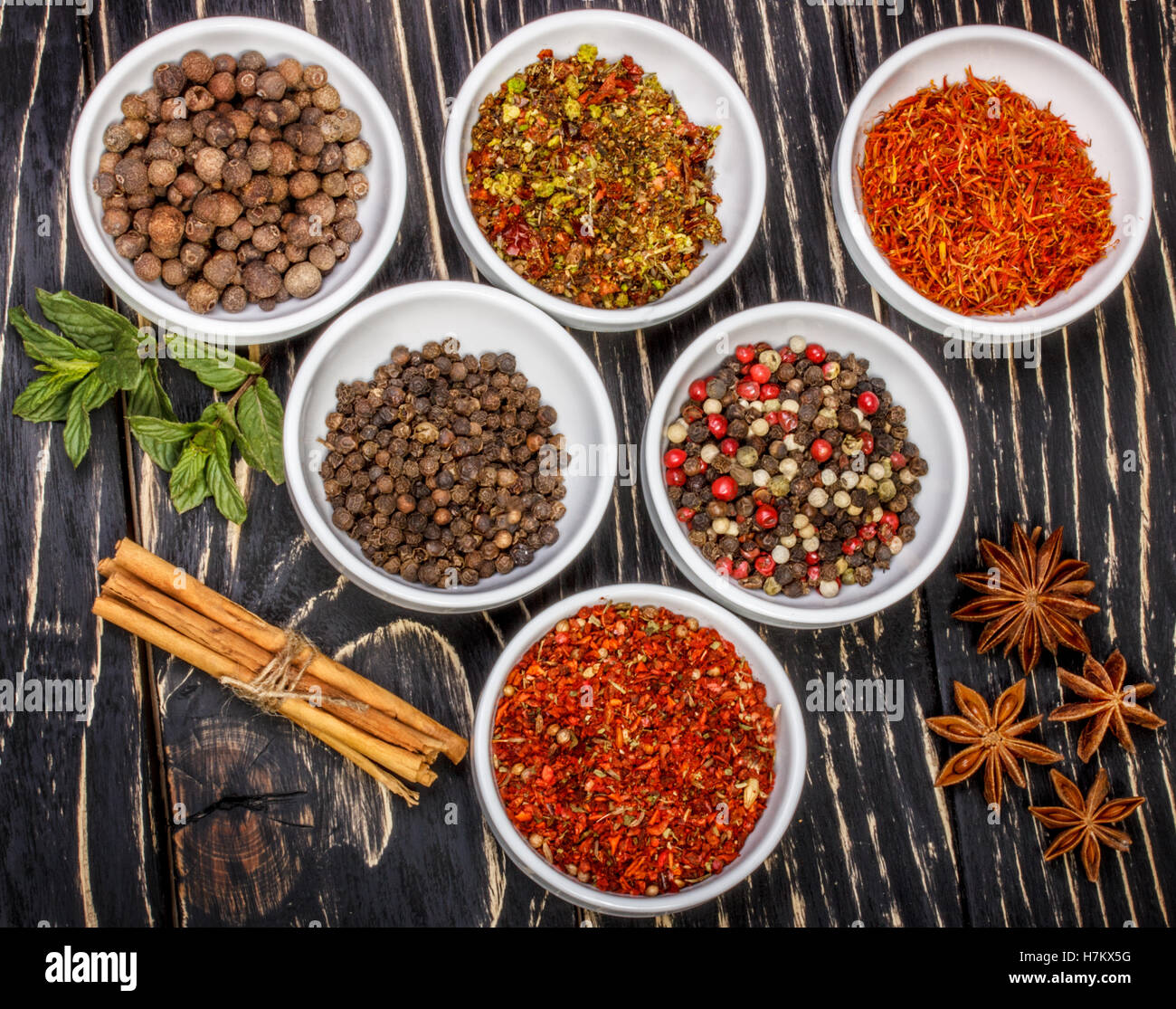 Colorful aromatic Indian spices and herbs on an old oak wooden brown ...