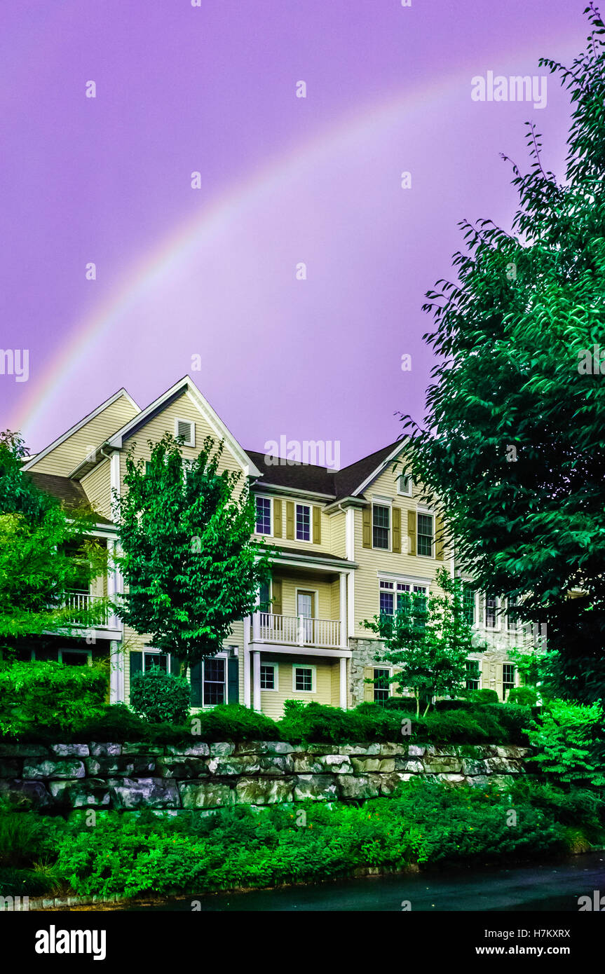 Rainbow over houses Stock Photo - Alamy