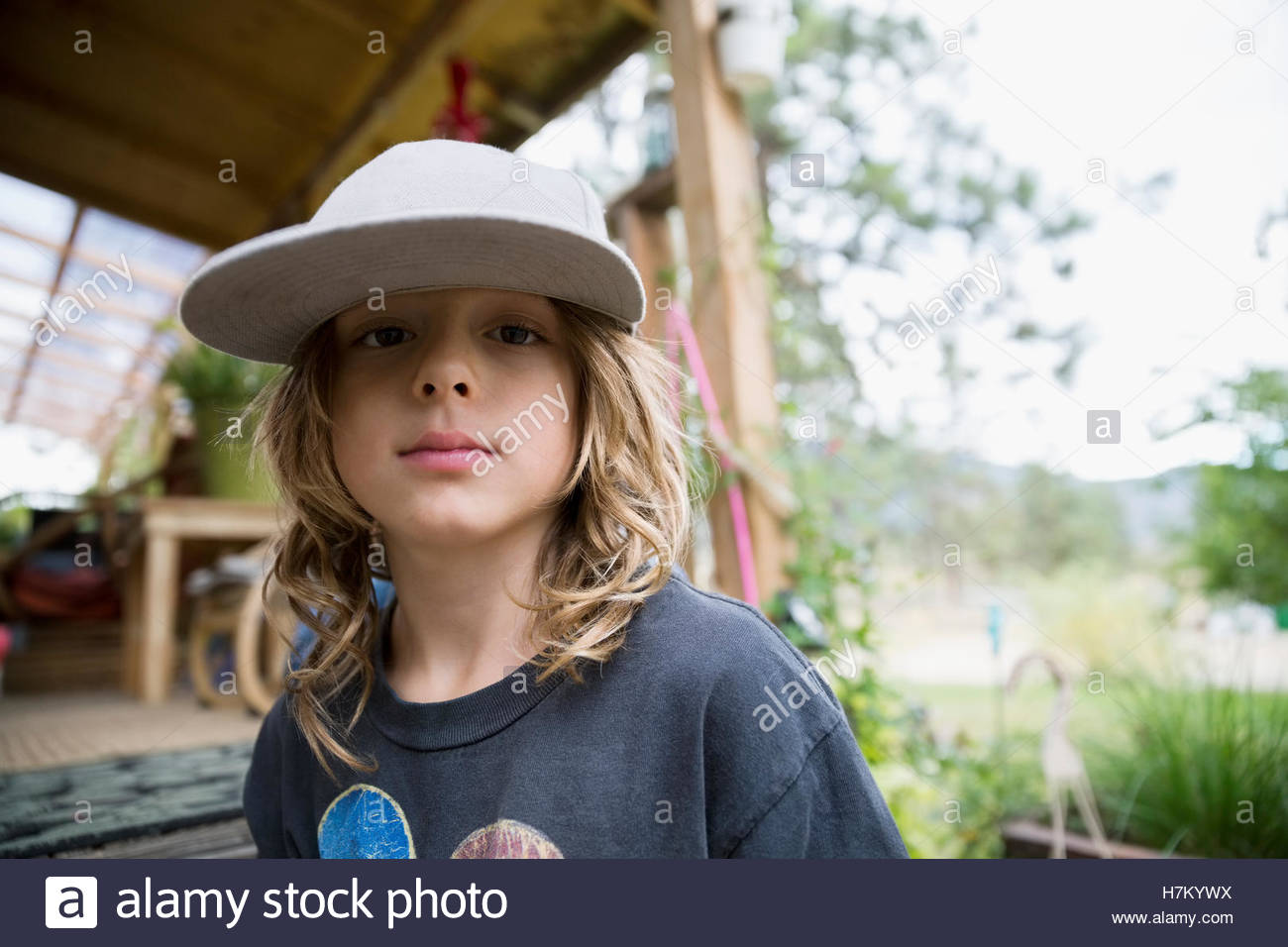 Portrait confident boy with long hair and baseball cap Stock Photo - Alamy
