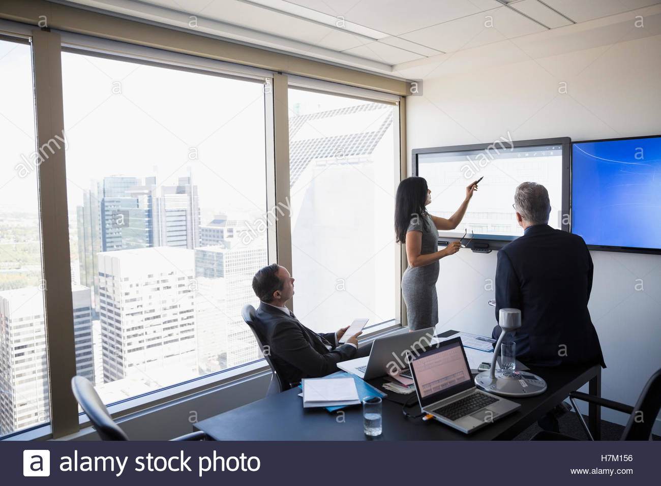 Business people pointing at monitor hi-res stock photography and images ...
