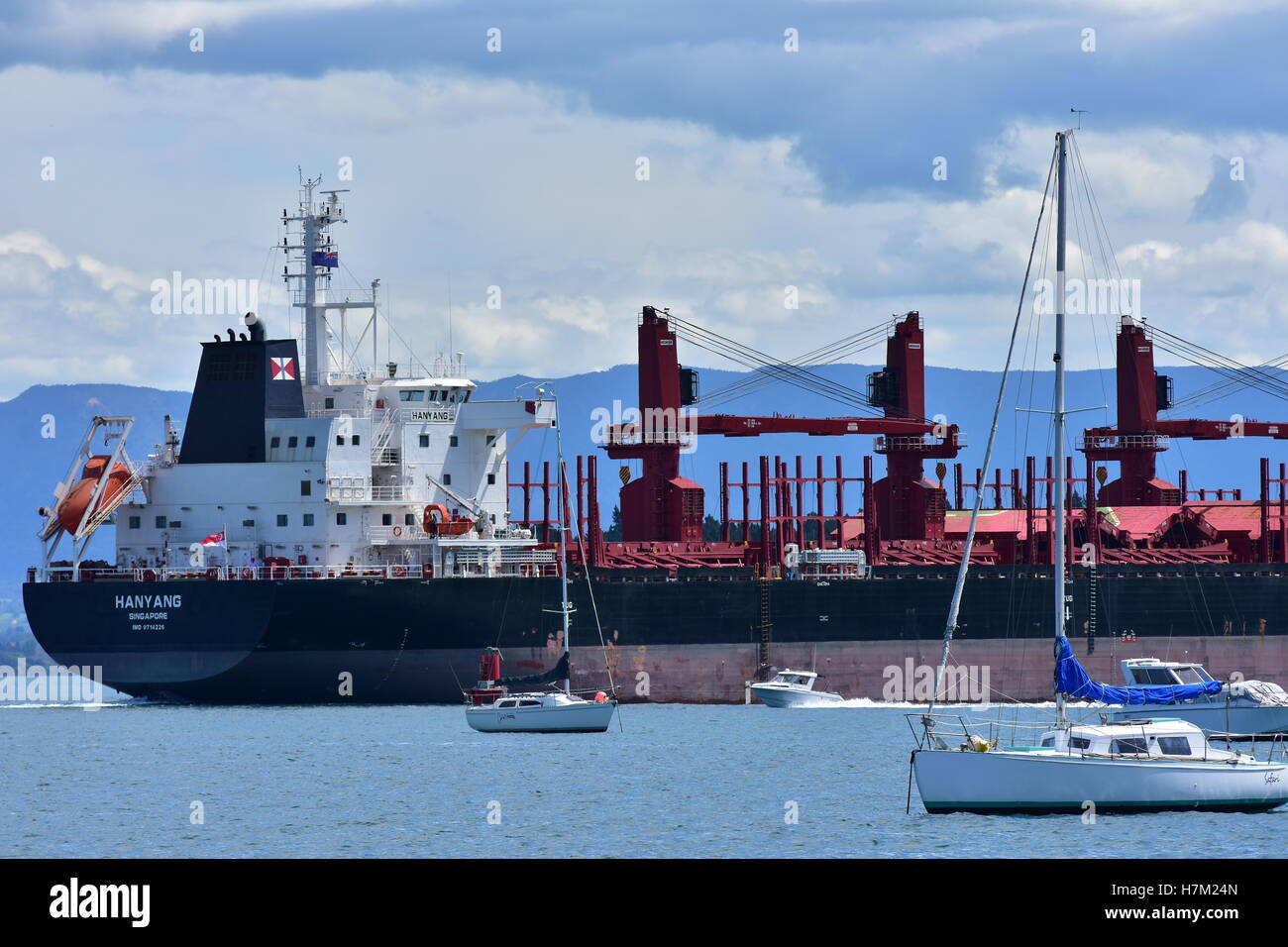 Cargo ship leaving port Stock Photo - Alamy