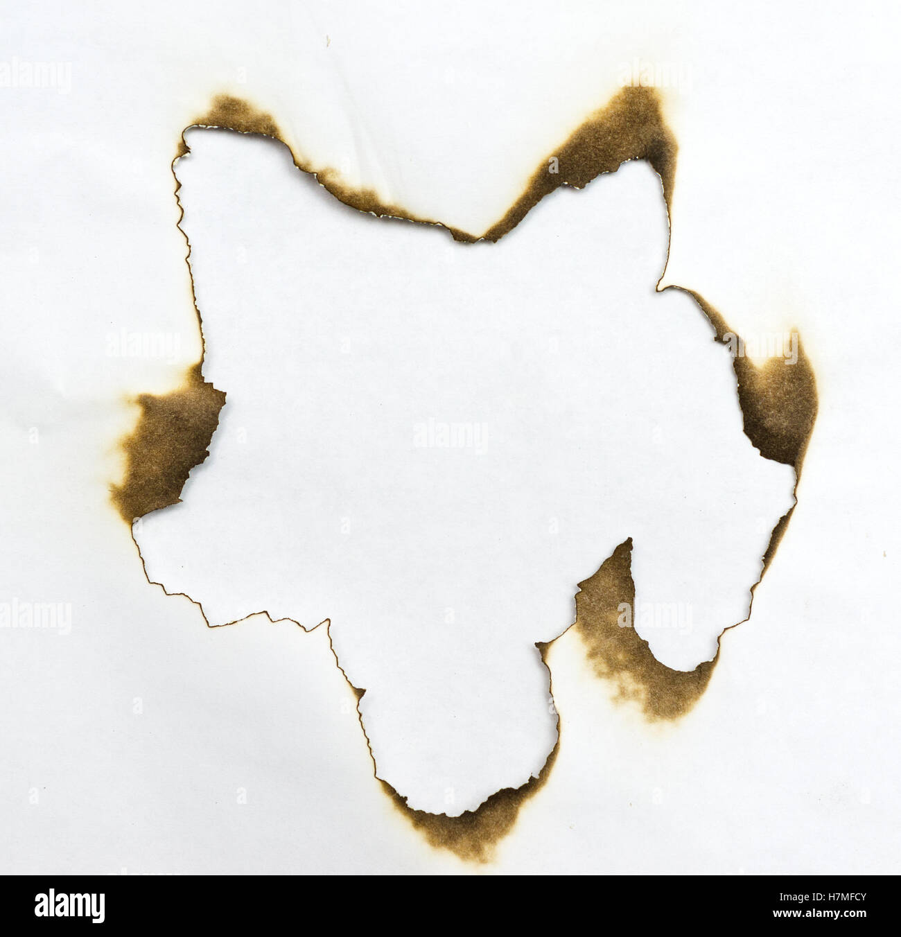 burned hole in a paper Stock Photo - Alamy