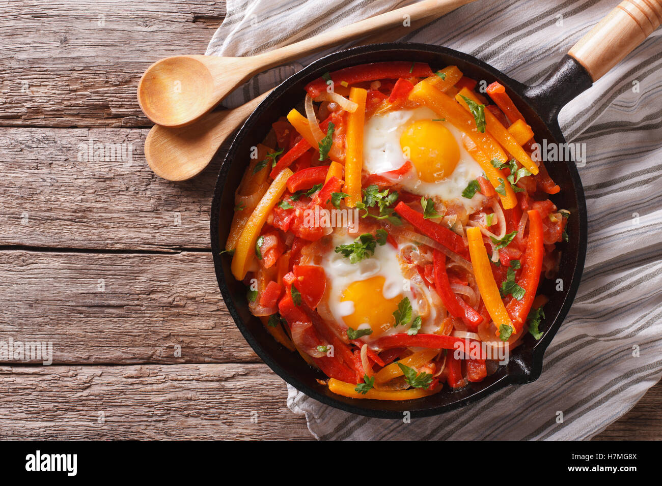 traditional Basque piperade with eggs close-up in a pan. horizontal ...