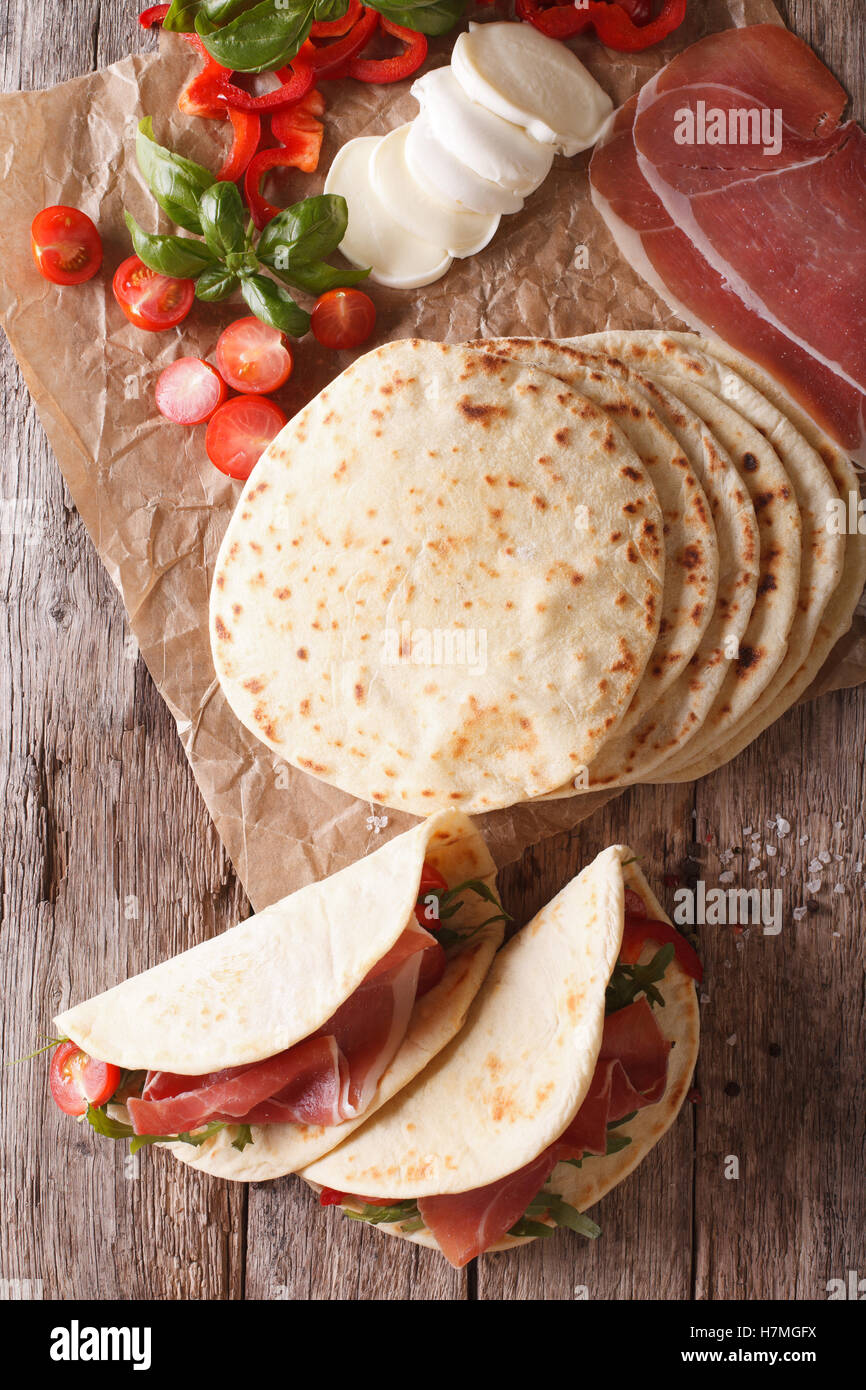 Italian street food: piadina with ham, cheese and vegetables close-up ...