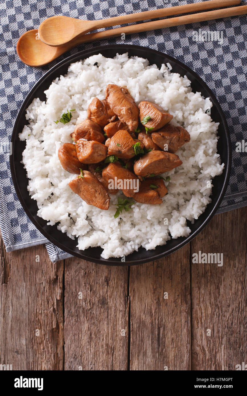 Philippine Adobo chicken with rice on a plate vertical view from above ...
