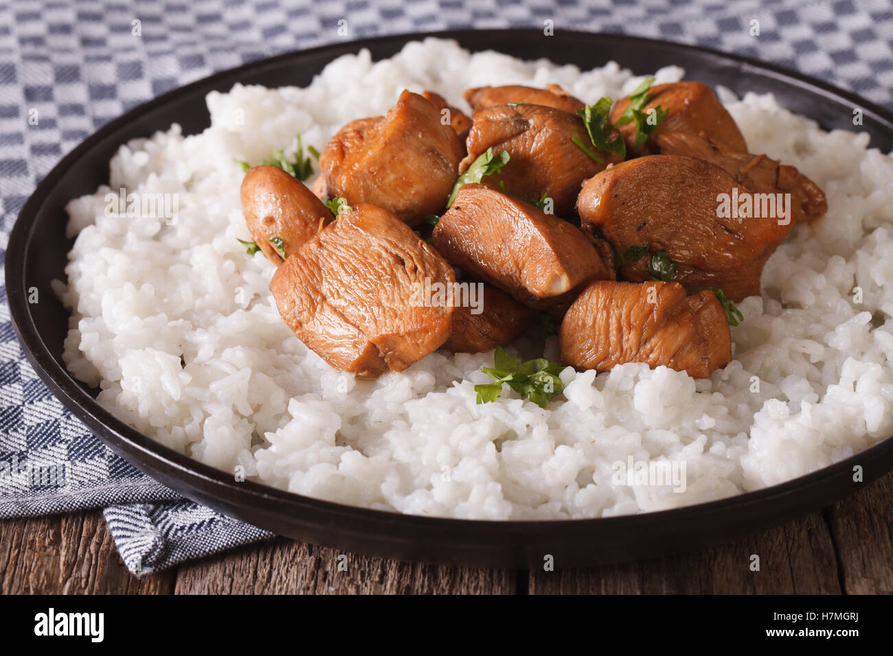 Adobo Chicken with a side dish of rice close-up on a plate. horizontal ...