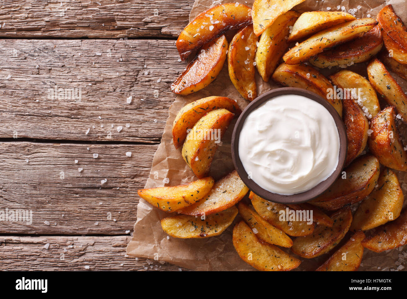 Fast food: Potato wedges and mayonnaise on the table. horizontal top ...