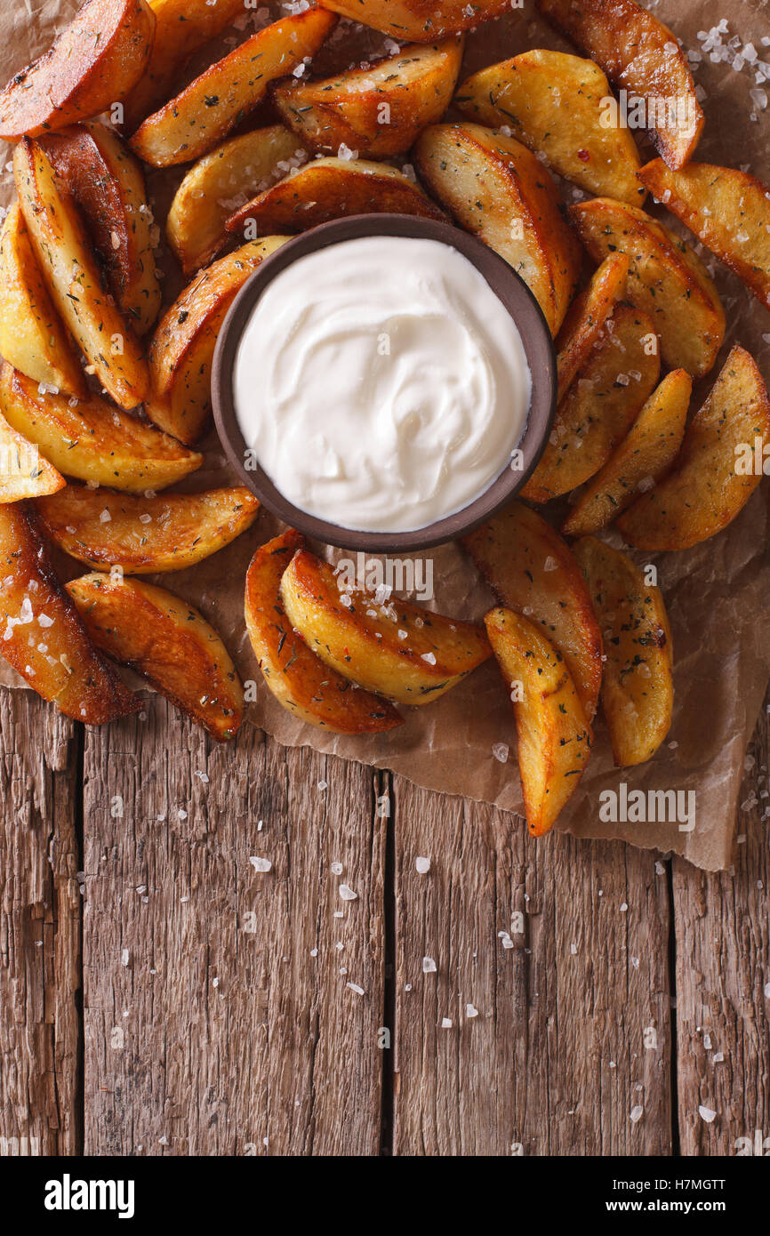 Fast food: Potato wedges and mayonnaise on the table. Vertical top view ...