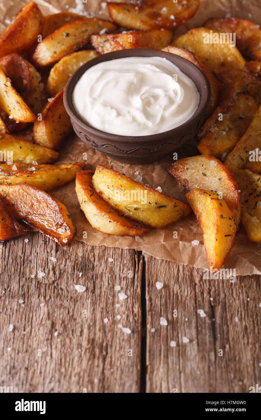 Fast food: Potato wedges and mayonnaise close-up on the table. Vertical ...