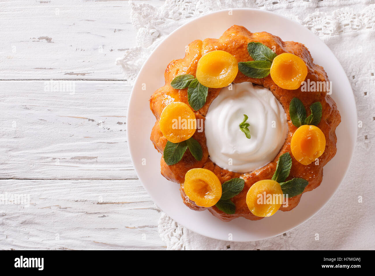 Savarin French dessert with apricots and whipped cream. vertical view ...