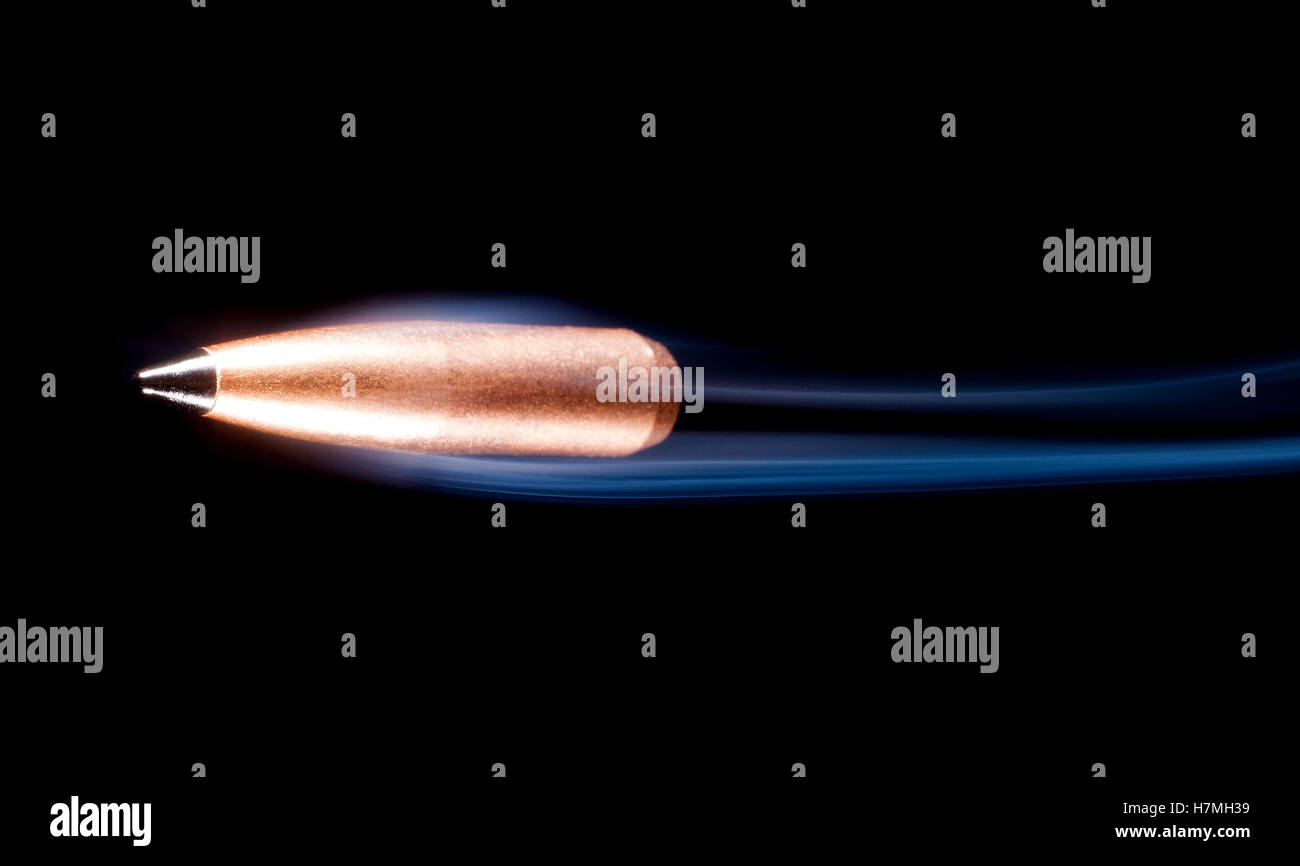 Polymer tipped bullet with copper plating with smoke on a black ...