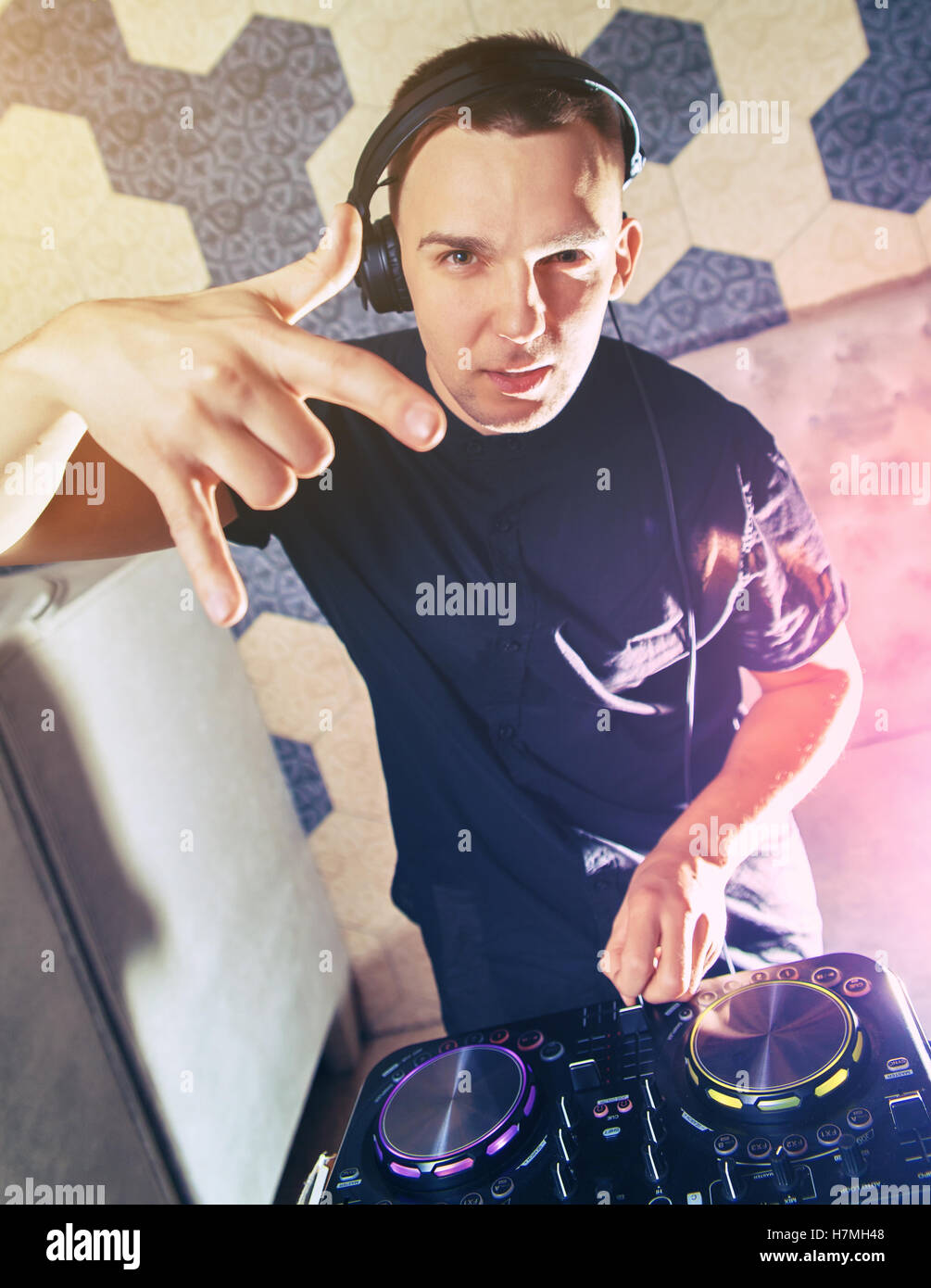 Young man DJ with mixer is working Stock Photo - Alamy