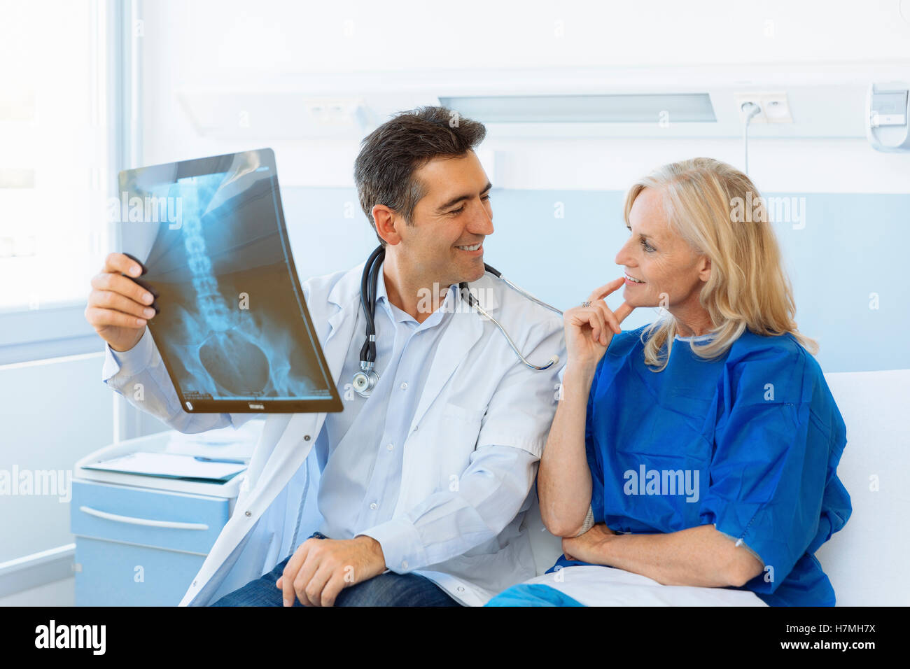 Doctor showing ray patient in hi-res stock photography and images - Alamy