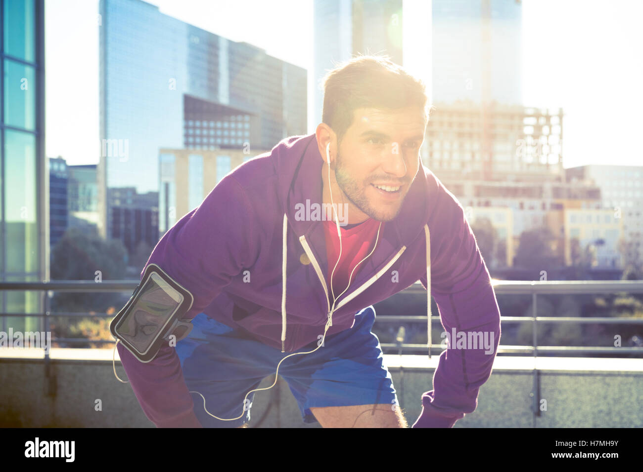 athlete with earphones running in the city Stock Photo - Alamy