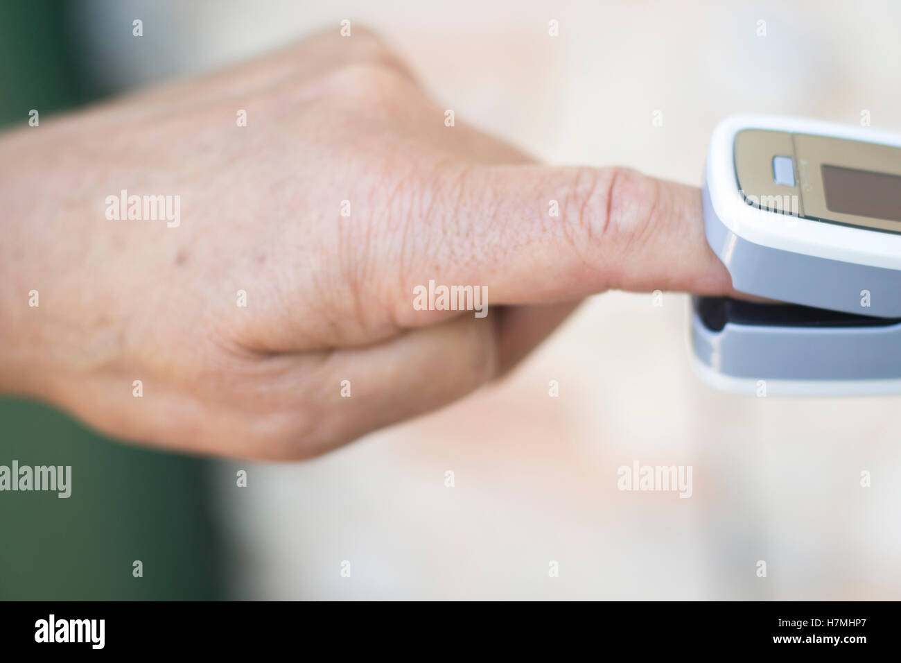 Portable hand held domestic cardiac finger pulse rate meter to show ...